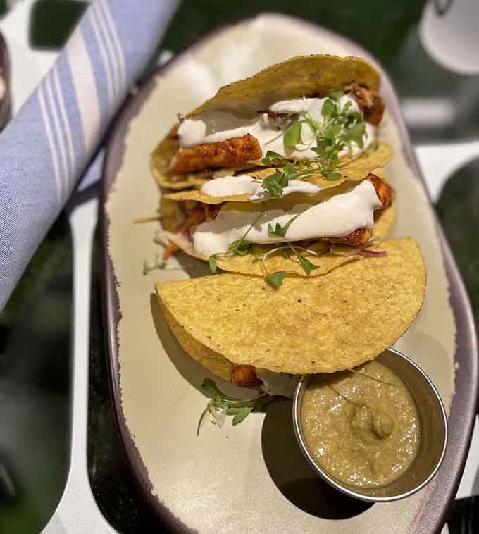These salmon tacos bring beachside vibes to Atlanta, complete with that perfect crema drizzle on top.