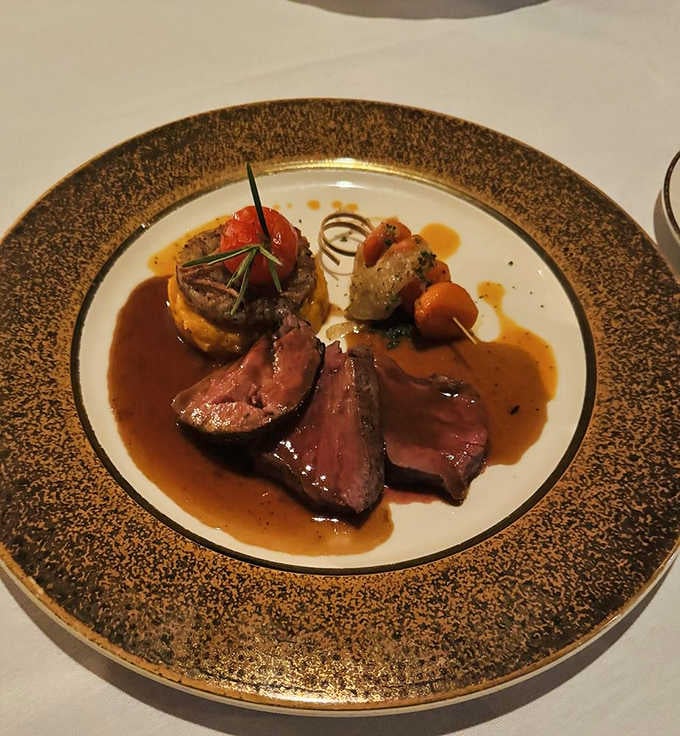 Pan-seared filet mignon that's sliced to reveal perfect doneness, proving some chefs actually understand what medium-rare truly means.