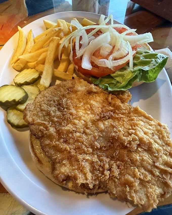 That golden, crispy tenderloin stretches beyond the bun's borders like it's trying to escape, and honestly, who could blame it?