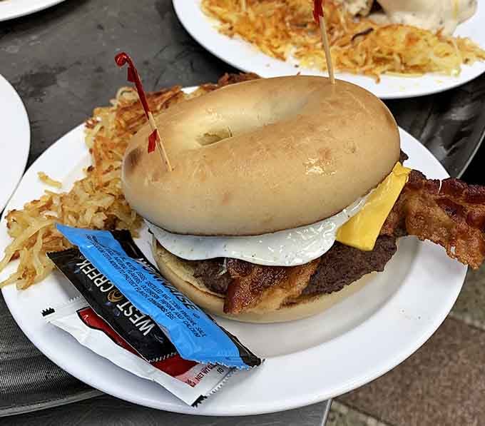 A breakfast sandwich on a bagel with bacon and hash browns proves that some architectural marvels are edible.