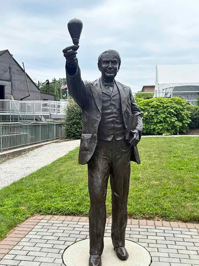 The man himself, forever holding aloft the invention that literally brightened the entire world.