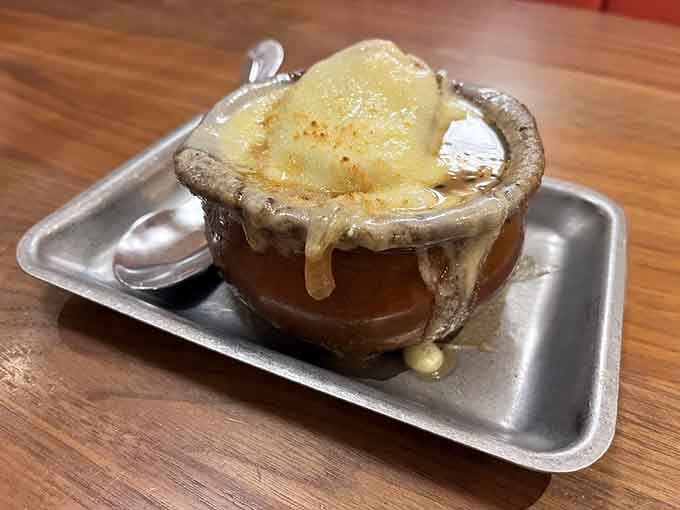 French onion soup with that glorious cheese cascade is comfort in a crock, bubbling with savory goodness and tradition.