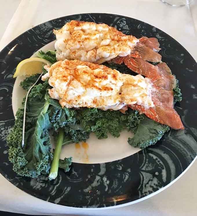 Lobster tails perched on a bed of greens like they're posing for their glamour shots, and honestly, they've earned it.
