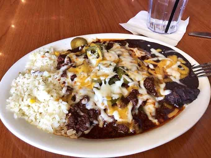 Chili enchiladas smothered in sauce and melted cheese prove that everything's better with more cheese on top.