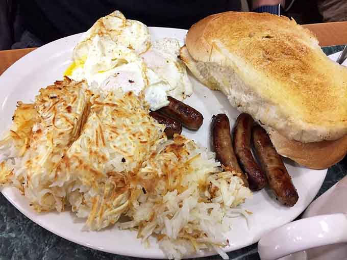 Golden hash browns, perfectly cooked eggs, and sausage links form the holy trinity of highway breakfast satisfaction.
