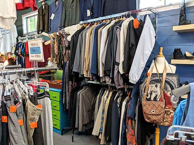 Men's coats hanging like a timeline of fashion choices, some questionable, all affordable now.
