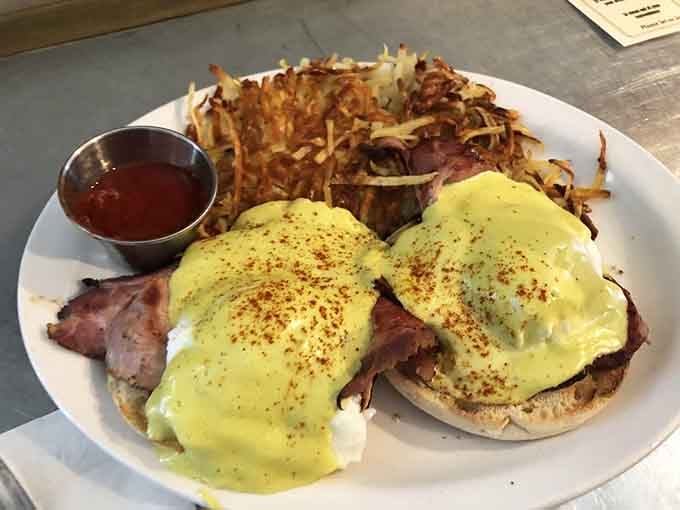 Eggs benedict with perfectly golden hollandaise and crispy hash browns, brunch goals officially achieved here.