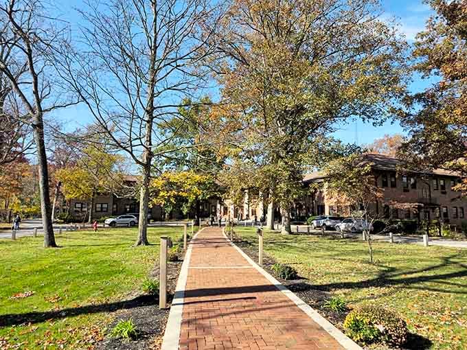 The brick pathway welcomes you to adventure, stretching toward rustic buildings that blend seamlessly with surrounding nature.