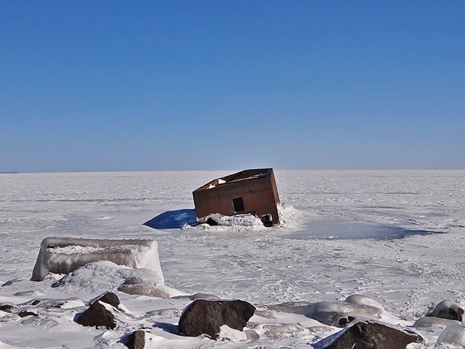 Winter transforms the scene into a frozen wonderland, with ice claiming everything except this stubborn concrete box's determination to exist.
