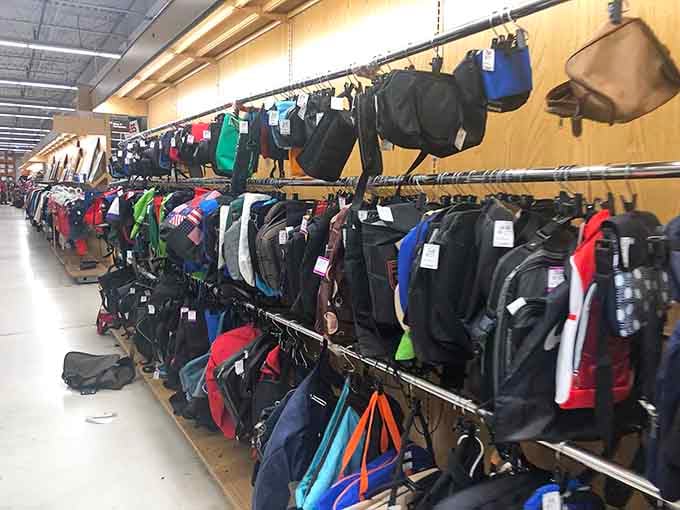 Backpacks galore hang like a rainbow of possibilities, ready for school, travel, or weekend adventures.