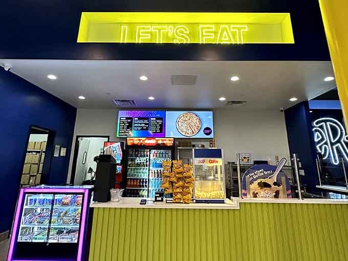 That "Let's Eat" sign glows with the promise of snacks, because bouncing around burns calories that demand immediate replacement.