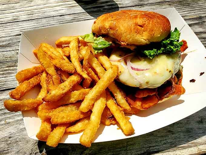 That towering cheeseburger situation with crispy fries proves that sometimes simple done right beats fancy every single time.