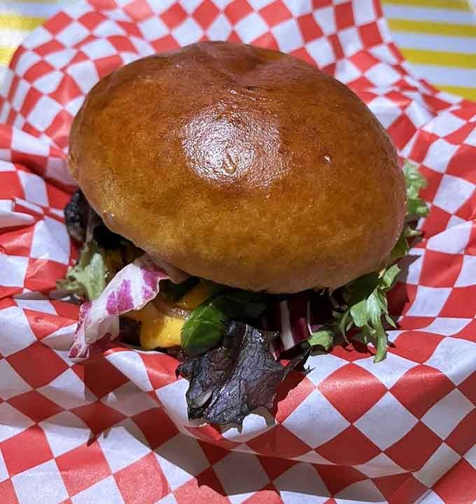 This burger sits pretty on its bun like it knows exactly how good it's about to taste.