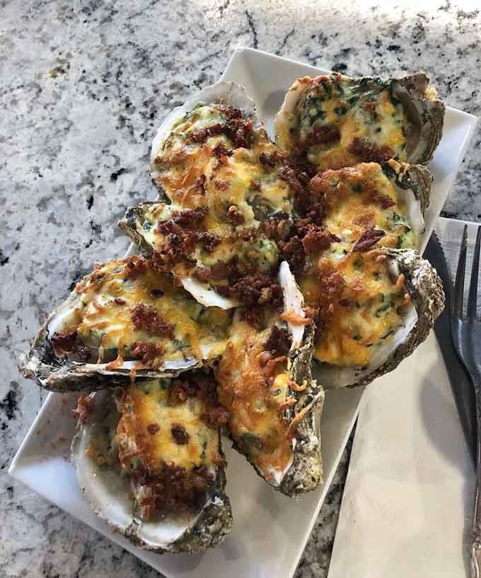 Oysters Rockefeller bubbling with cheese and bacon: because sometimes oysters need a little extra love and butter.