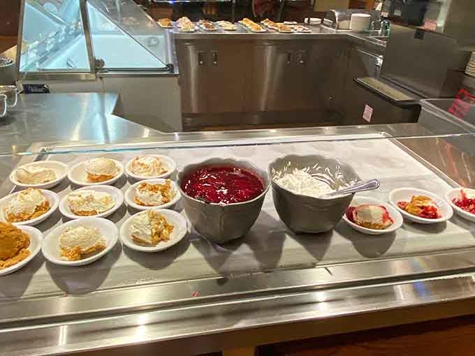 The dessert station stretches on like a sweet dream, with pies and puddings creating an edible landscape of pure temptation.