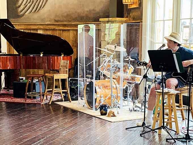 Live music, a grand piano, and plexiglass dividers that say "we care" create the perfect entertainment atmosphere.