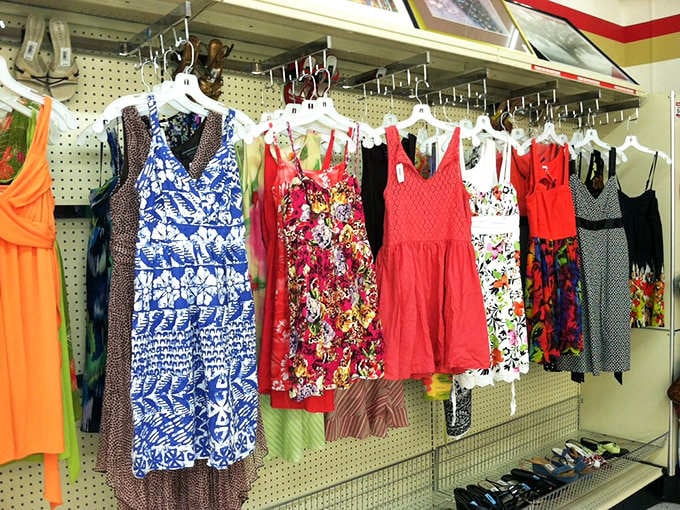 These colorful dresses hang like a rainbow of second chances, each pattern telling its own fabulous story.