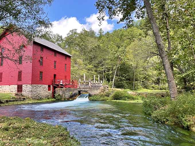 A crimson mill beside a rushing creek—someone's basically painted a Norman Rockwell scene in three dimensions here.