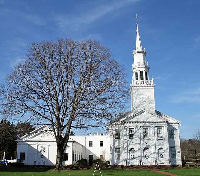 That pristine white steeple reaches toward blue skies like it's been doing for generations of Sunday services.