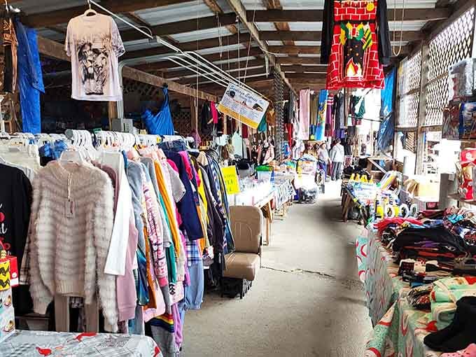 Hanging clothes create a rainbow corridor of possibilities where your next favorite outfit waits patiently to be discovered.