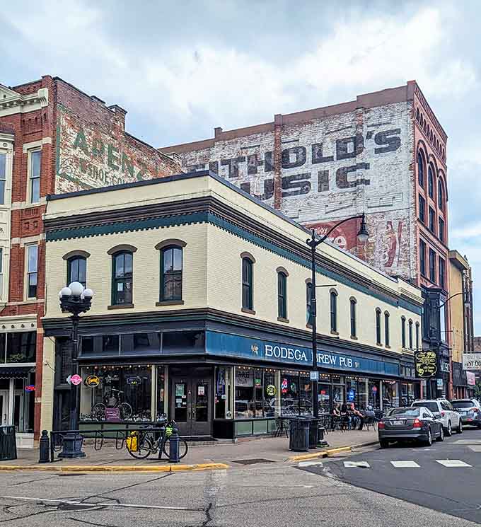 That faded ghost sign advertising days gone by adds character to this corner pub where the past refuses to stay buried.