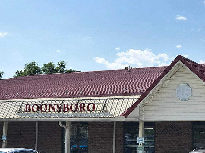The classic storefront lettering announces antique adventures waiting inside this treasure-filled building under summer clouds.