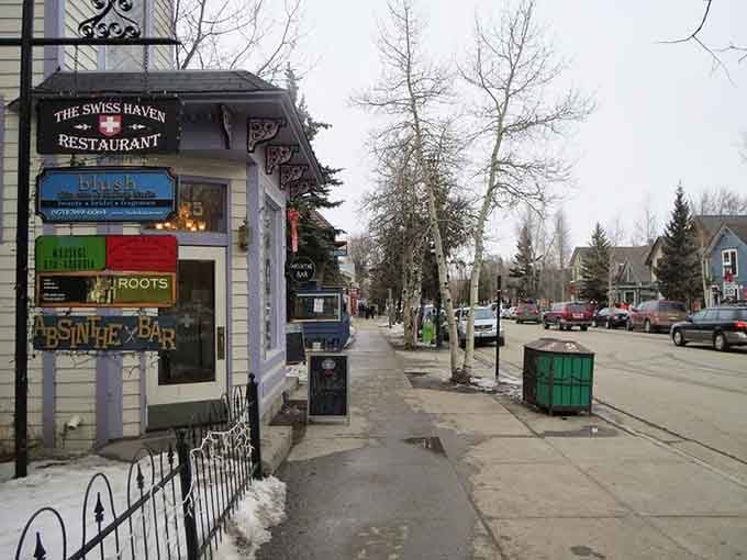 The Swiss Haven's ornate woodwork and cozy storefront promise Alpine flavors on a quiet street where winter lingers beautifully.