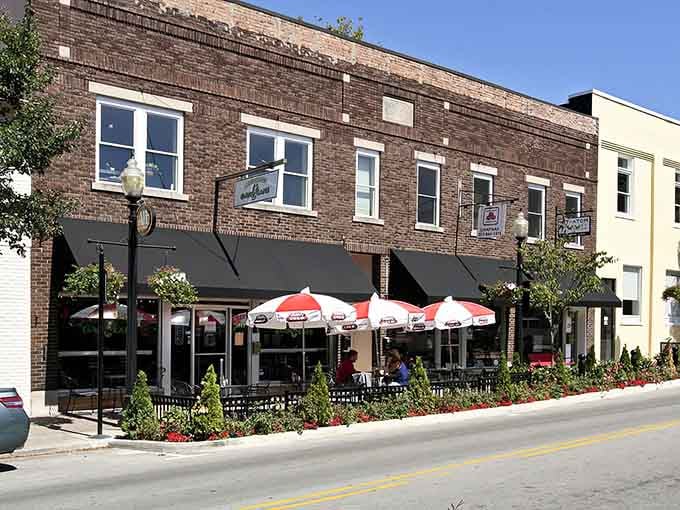 Outdoor dining under cheerful umbrellas turns every meal into a celebration of good weather and company.