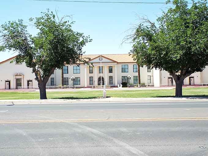 Stately trees shade the courthouse lawn, offering cool respite under Arizona's brilliant blue skies.