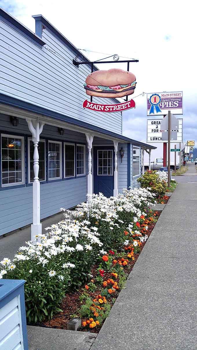That giant hamburger sign hanging above the street is basically a delicious beacon calling hungry travelers home to comfort.