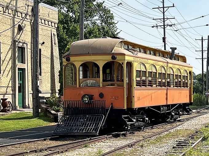 The vintage trolley's rounded roof and warm orange glow evoke memories of when streetcars ruled American city streets.