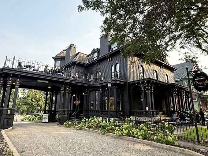 This elegant Victorian mansion glows with warmth, inviting you to dine where mysterious guests might join you.