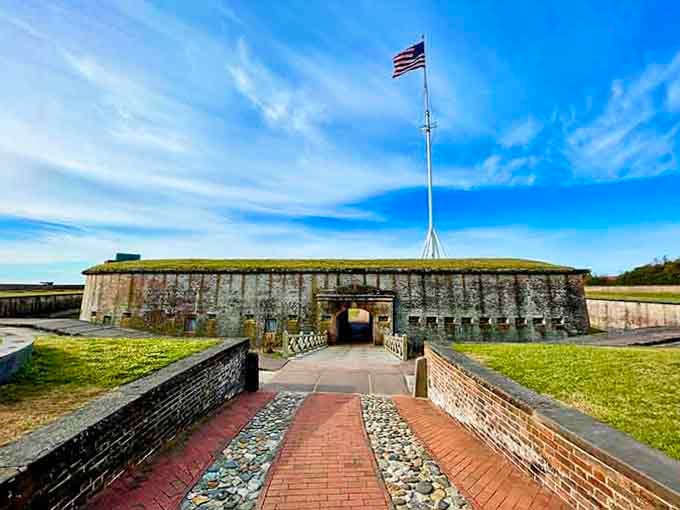 The brick walkway leads across the moat to thick fortress walls that once protected soldiers who never imagined tourists would follow.