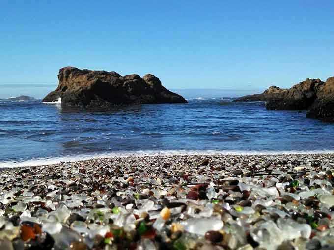 Smooth glass pebbles blanket the shore in every color, nature's way of recycling with serious style.