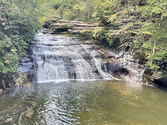 Water cascades over layered rock shelves like a wedding cake designed by Mother Nature herself.