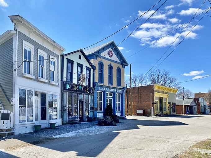 Historic storefronts painted in soft colors create a peaceful streetscape that feels like stepping into yesterday's embrace.