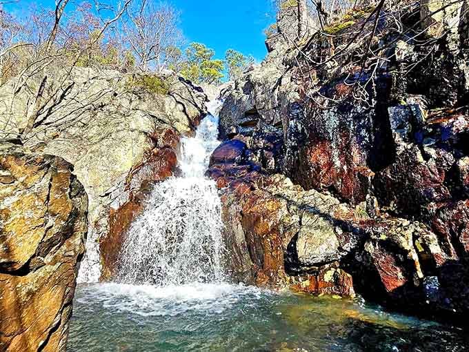 Water tumbles over rocks painted in brilliant reds and oranges, creating Missouri's most colorful cascade at 132 feet.