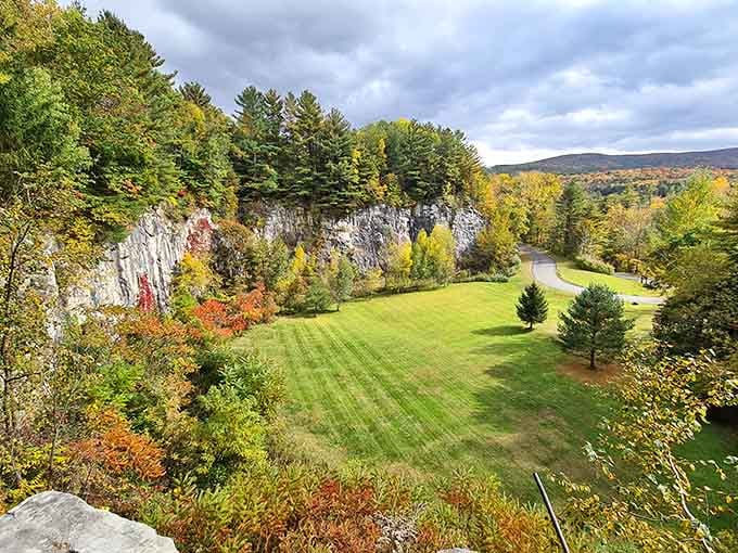 Autumn paints the landscape in brilliant reds and golds, framing this natural wonder like a postcard come to life.