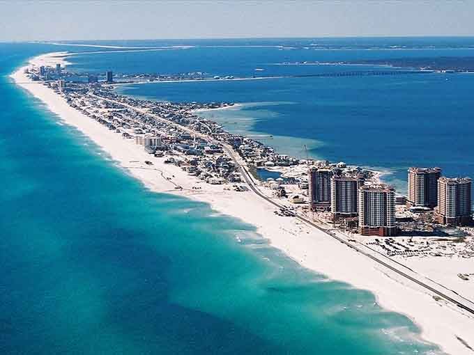 That sugar-white sand stretches endlessly along the Emerald Coast, where turquoise waters meet beaches that look almost too perfect.
