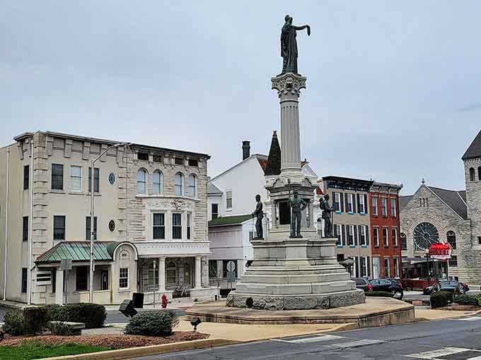 A monument stands watch over colorful storefronts, reminding everyone that history and community pride go hand in hand here.