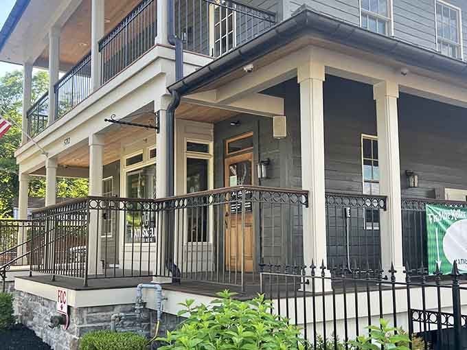 The elegant porch and wrought-iron details suggest Southern hospitality meets theatrical magic in one beautiful package.