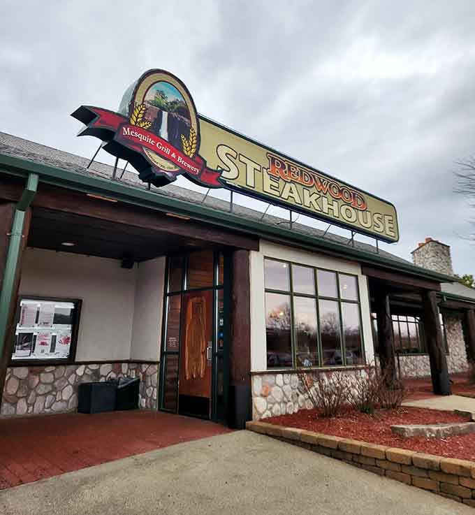That vintage-style sign glowing against the stone facade could guide hungry travelers from miles away like a delicious beacon.