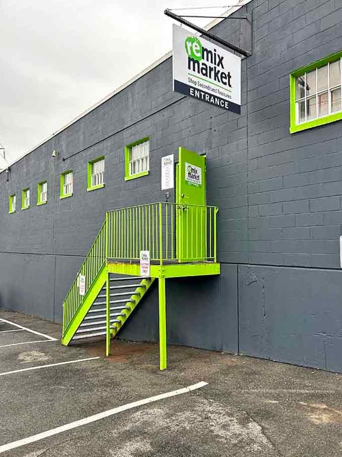 The lime-green staircase pops against gray walls like a highlighter marking the path to secondhand gold.