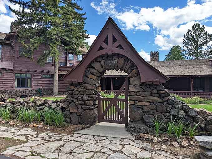 The stone archway entrance feels like stepping into a fairytale where lumber barons once lived among towering pines.
