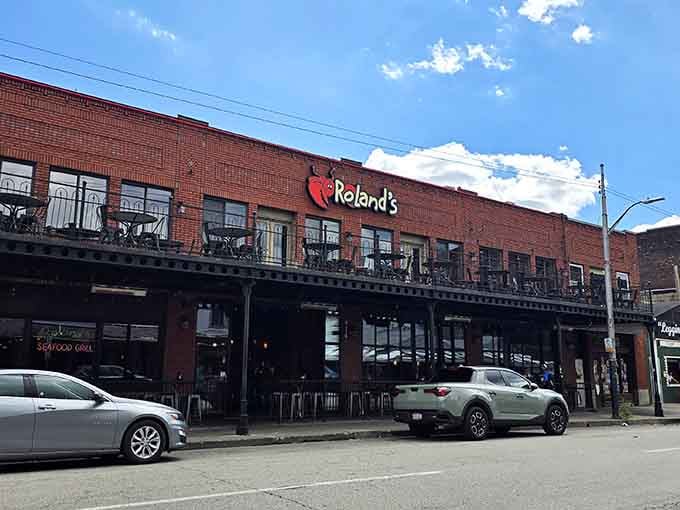 That brick facade and balcony seating promise fresh catches in Pittsburgh's historic Strip District where seafood dreams come true.