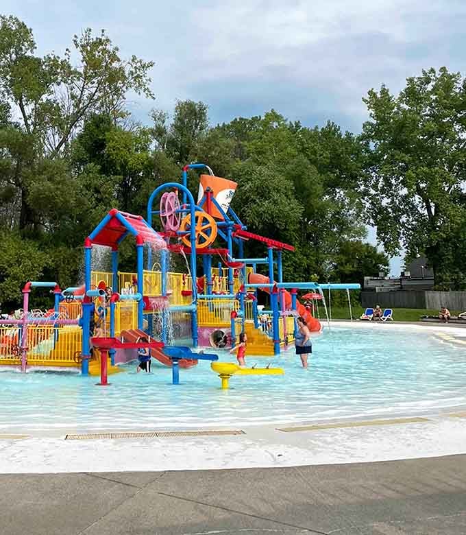 This rainbow explosion of water features looks like Willy Wonka designed a splash pad—pure joy in primary colors.