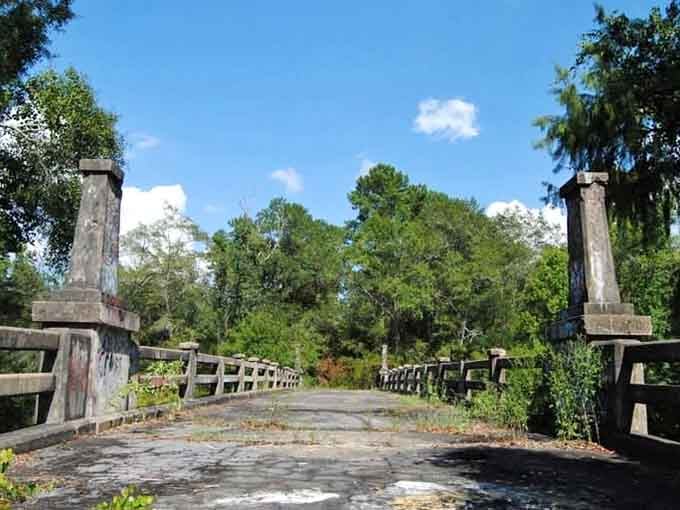 Weathered posts mark the entrance to this legendary crossing where local tales outnumber the planks on the bridge.