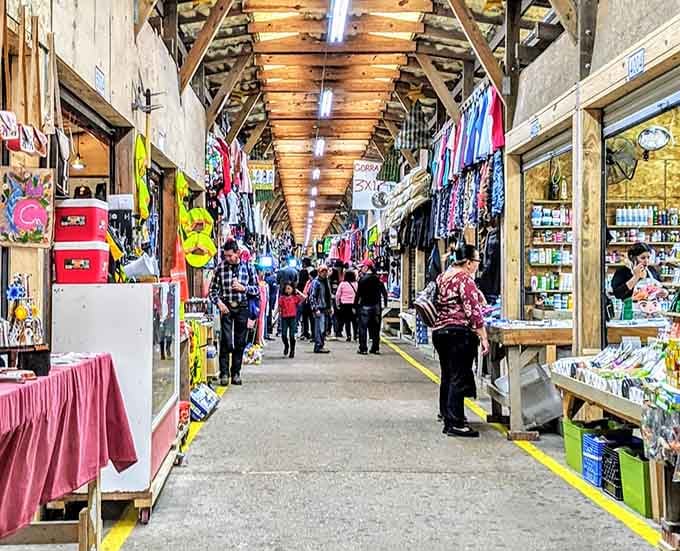 Wooden beams frame this shopping corridor where clothing and accessories hang like an indoor street fair minus the parking hassles.