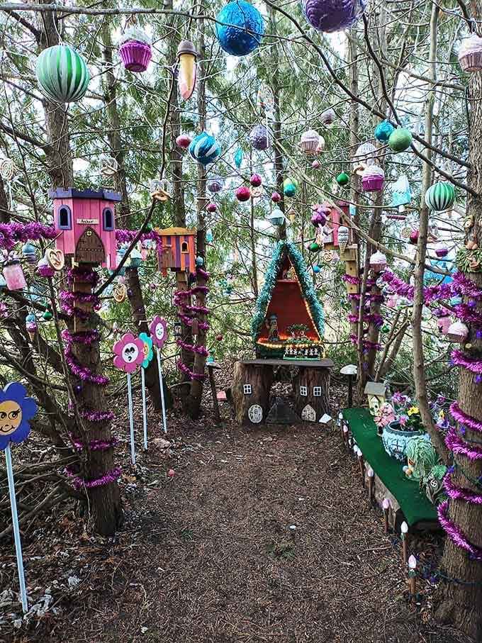 Tiny fairy houses nestle among the trees, draped in purple garland and glittering ornaments like Christmas morning.