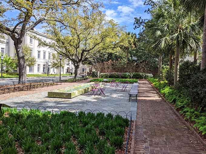 Brick pathways wind through manicured gardens where live oaks provide shade like nature's own parasols overhead.